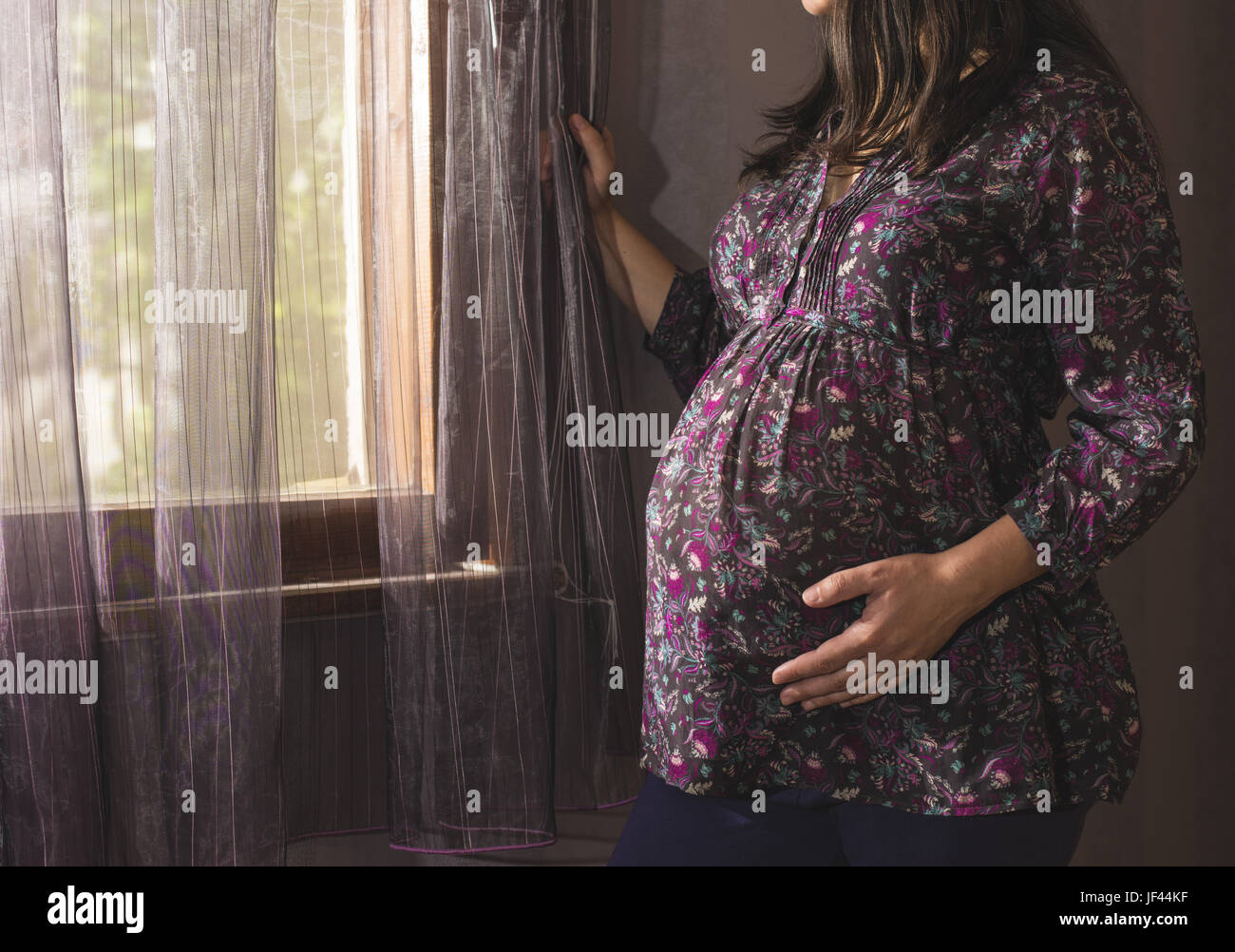 Pregnant women to the window Stock Photo - Alamy