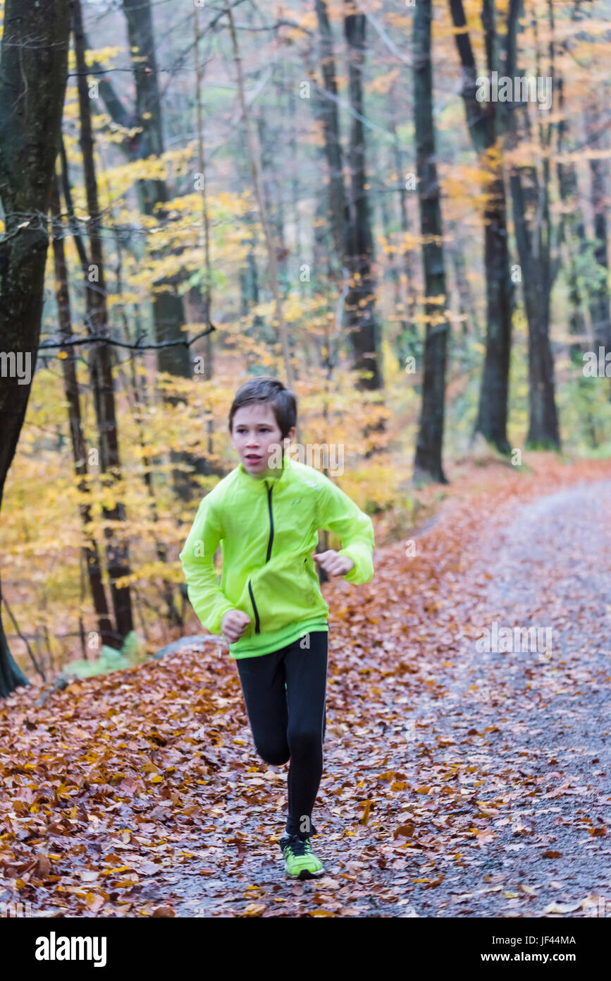 Boy running in park Stock Photo - Alamy