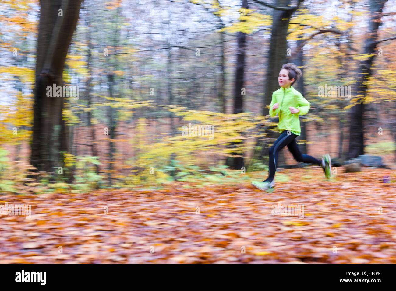 Boy running in park Stock Photo - Alamy