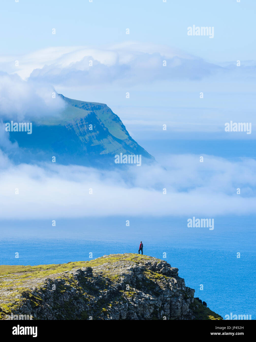 Seaside cliffs, person on background Stock Photo - Alamy