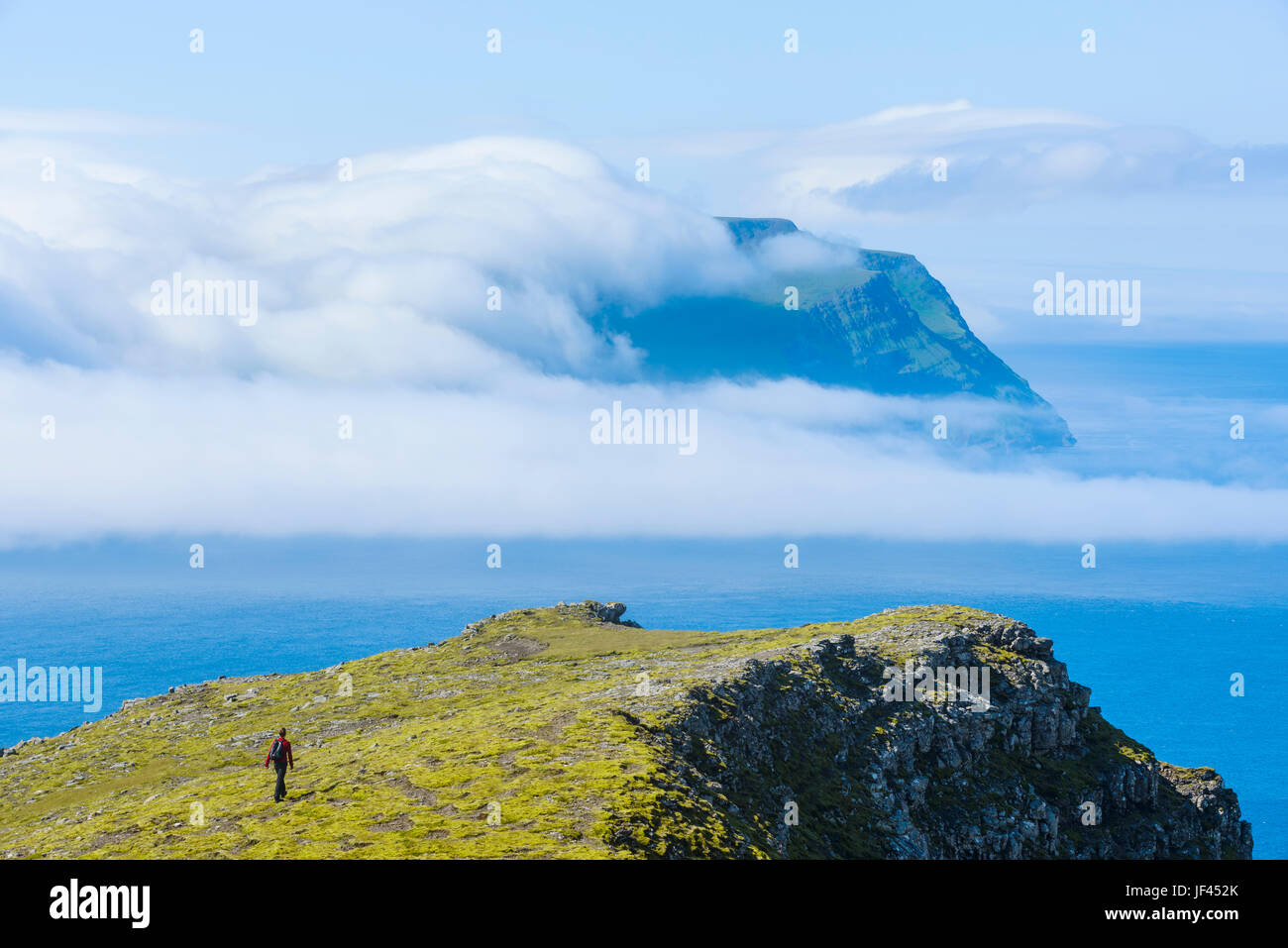 Person walking on cliff Stock Photo - Alamy