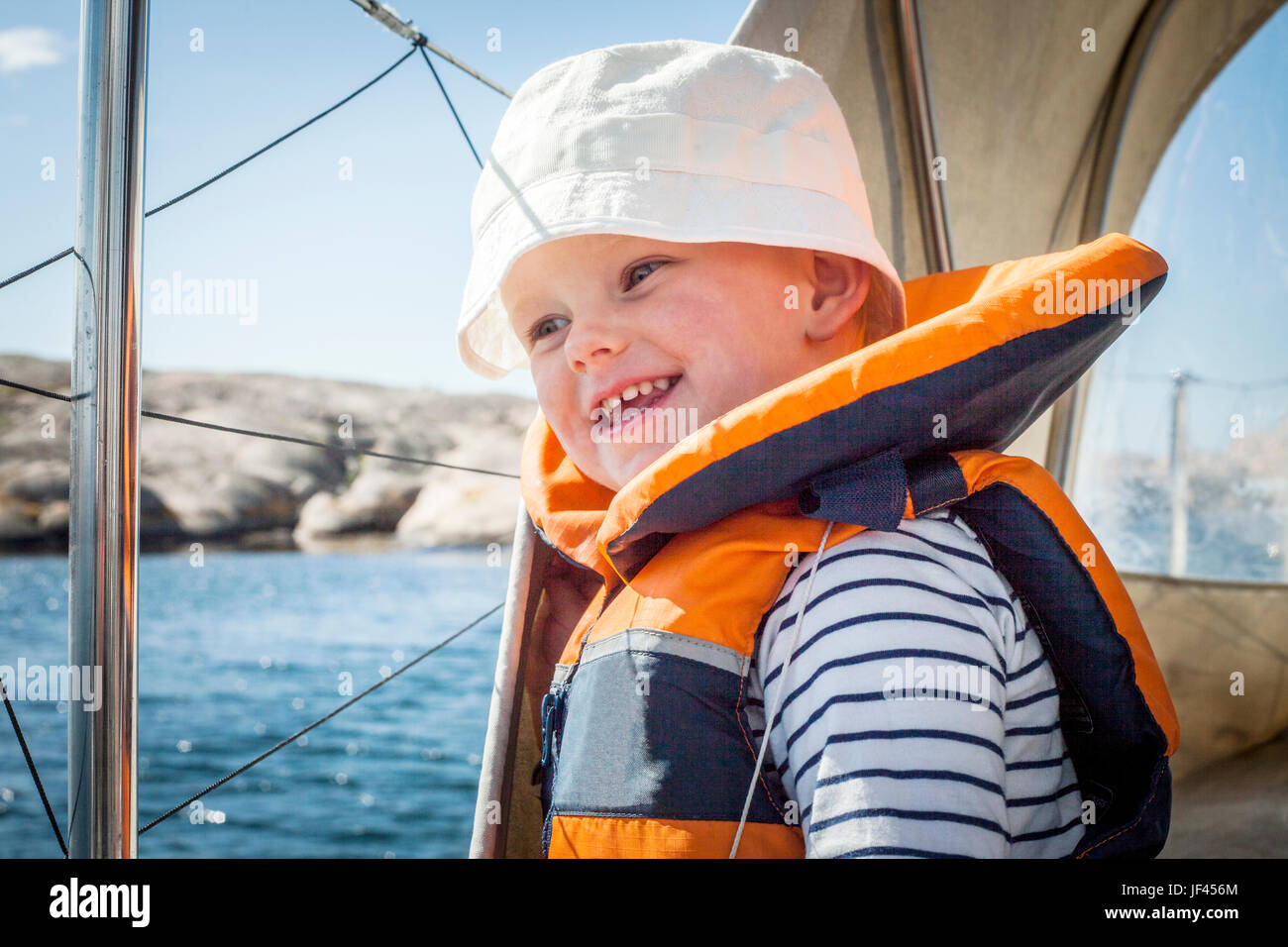 Smiling boy wearing life jacket Stock Photo - Alamy