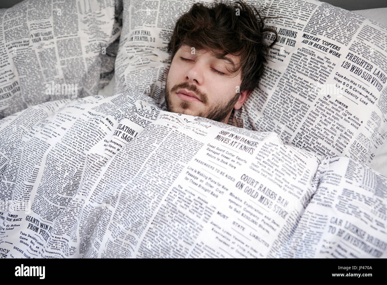 Young man sleeping newspaper hi-res stock photography and images - Alamy