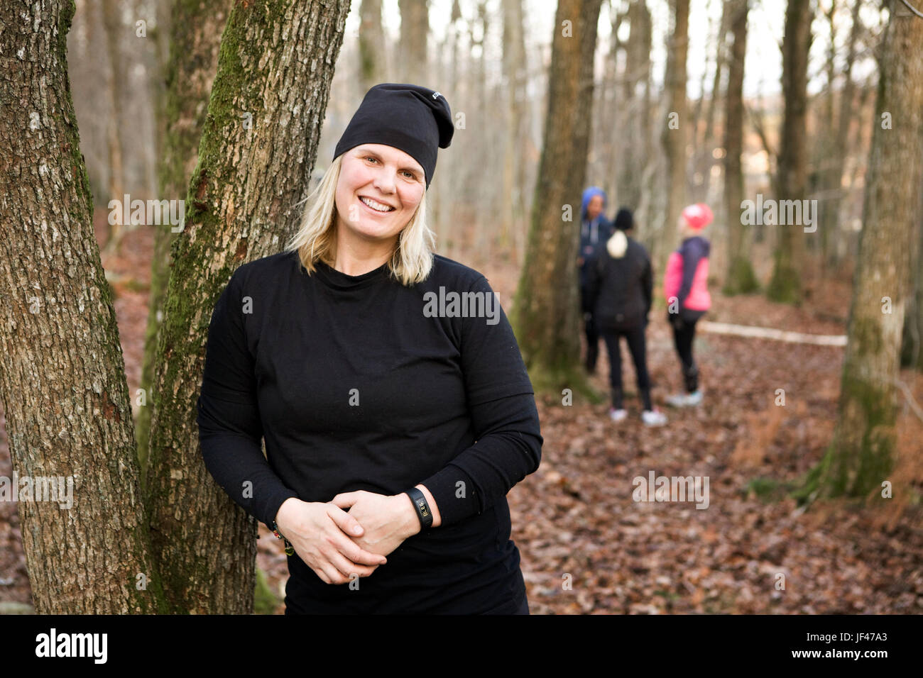 Smiling woman in forest Stock Photo - Alamy