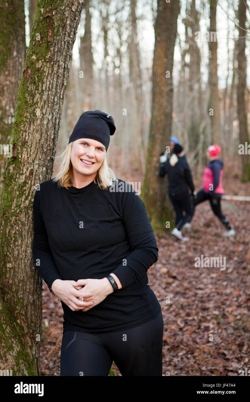 Smiling woman in forest Stock Photo - Alamy