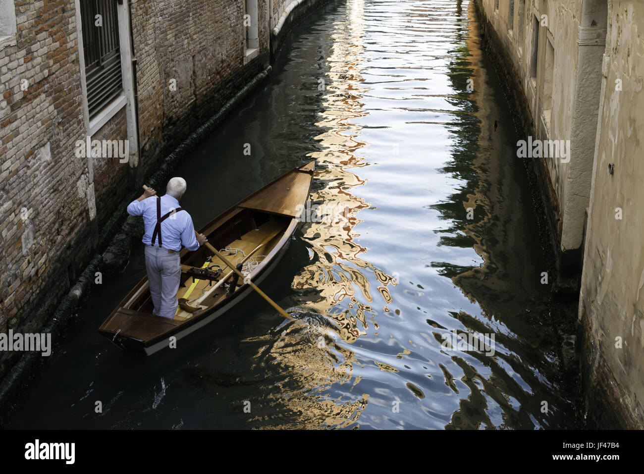 Man on a boat in Venice Stock Photo - Alamy