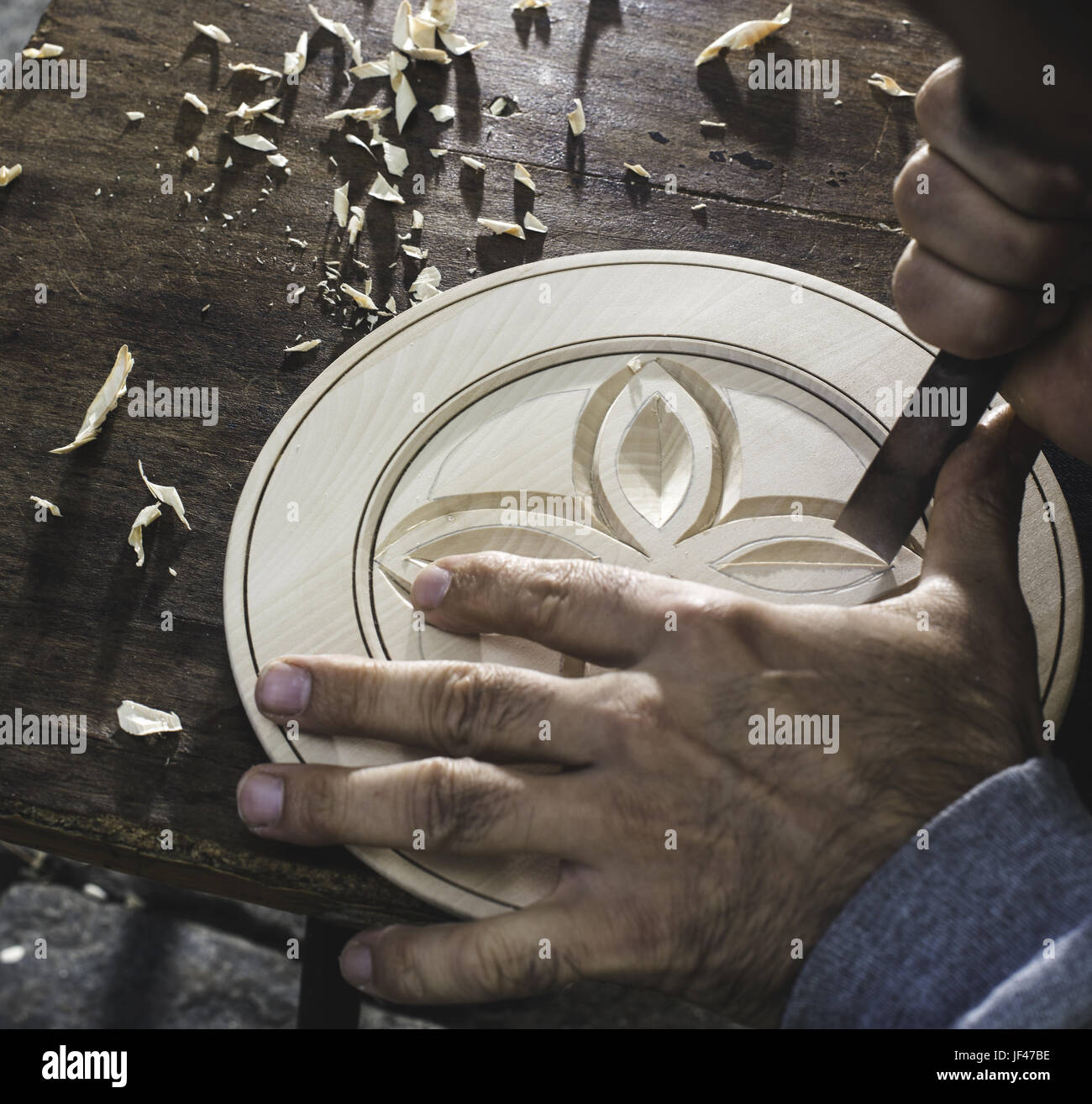 Hands of woodcarver make wooden bowl Stock Photo - Alamy