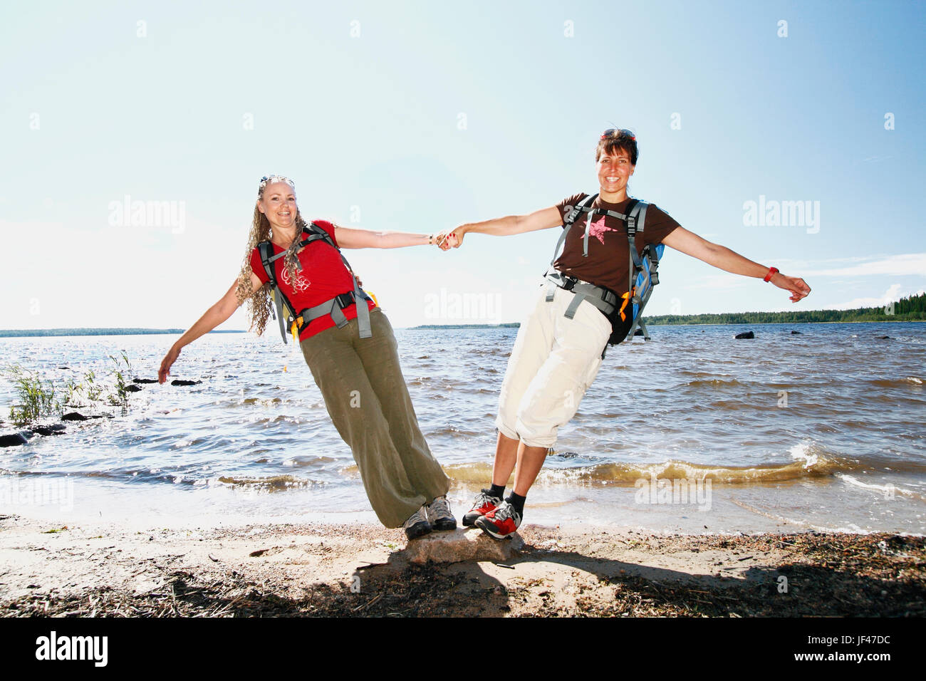 Smiling female friends at water Stock Photo - Alamy