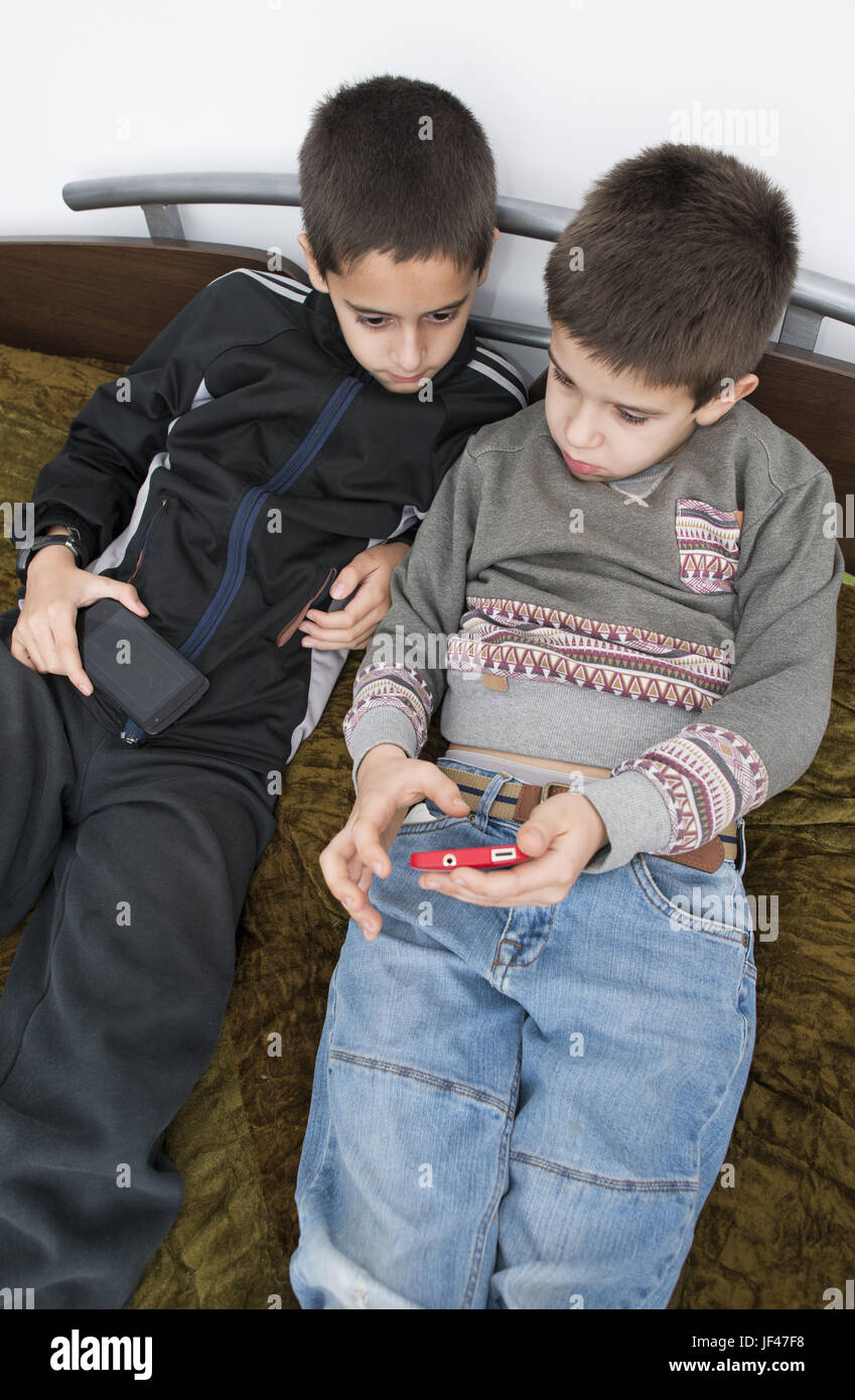Children playing with their smartphones Stock Photo - Alamy