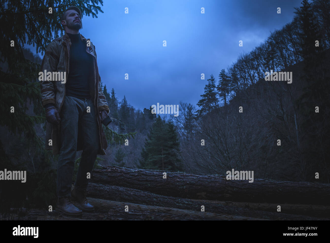 Young man in the forest at night Stock Photo - Alamy