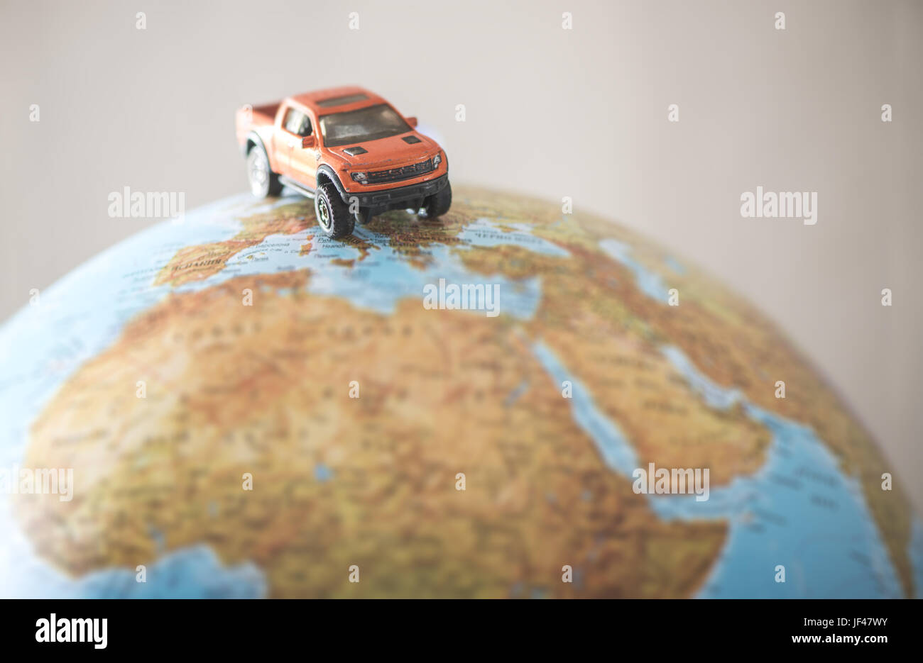 Offroad car on globe Stock Photo - Alamy