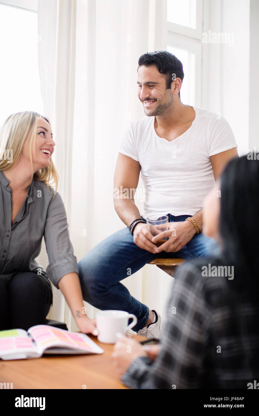 Friends sitting together Stock Photo - Alamy