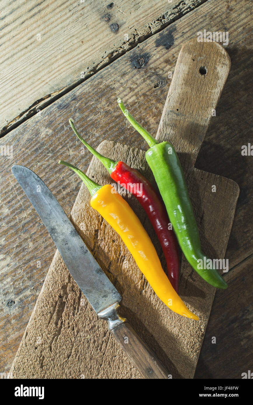 Hot peppers on wooden cutting board Stock Photo - Alamy