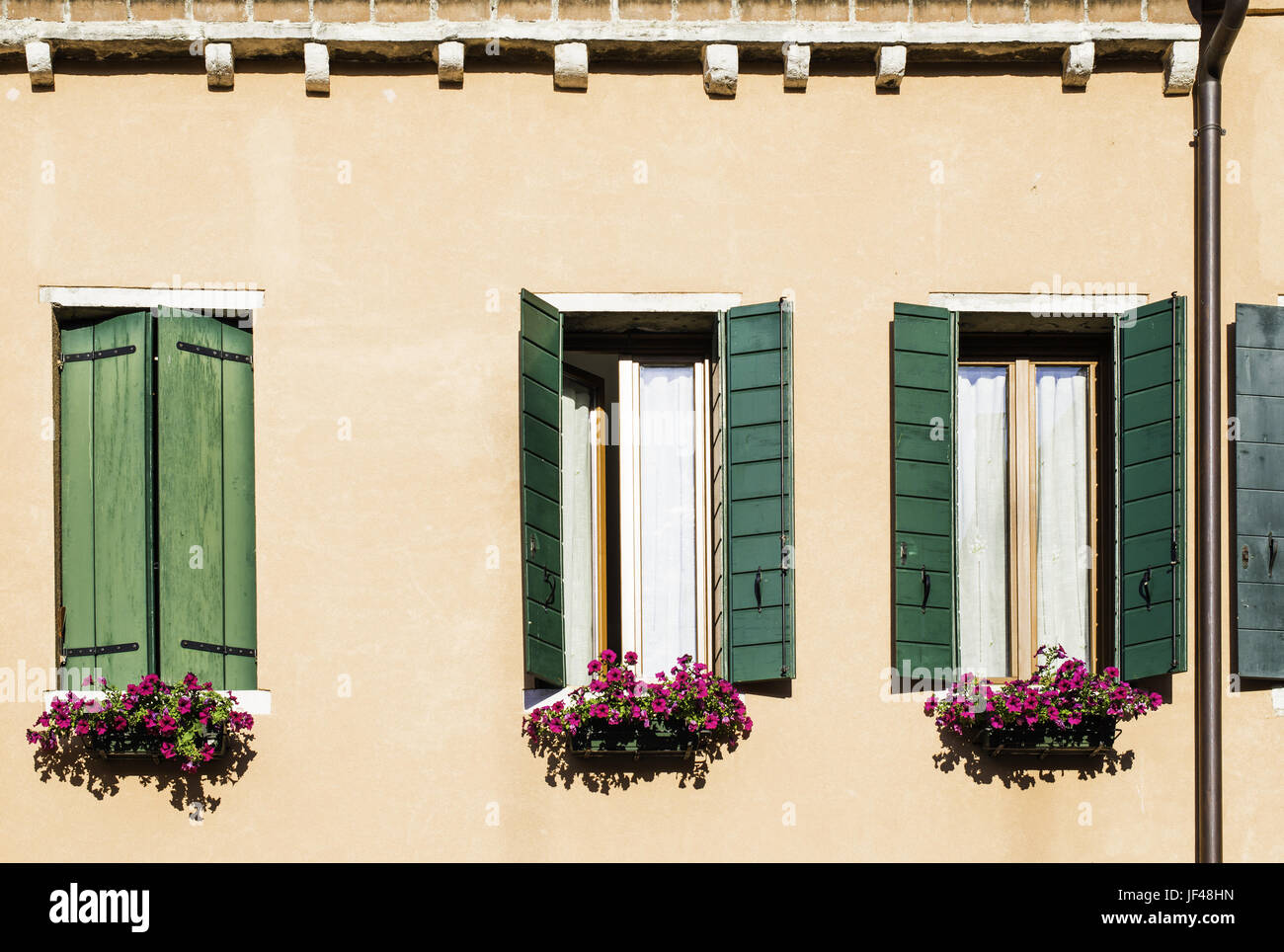 Venetian windows with flowers Stock Photo - Alamy