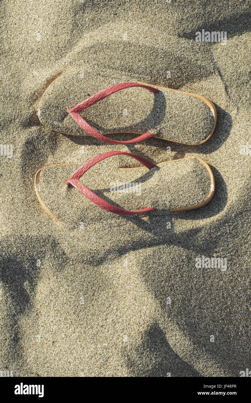 Sandals on the beach in the sand Stock Photo - Alamy