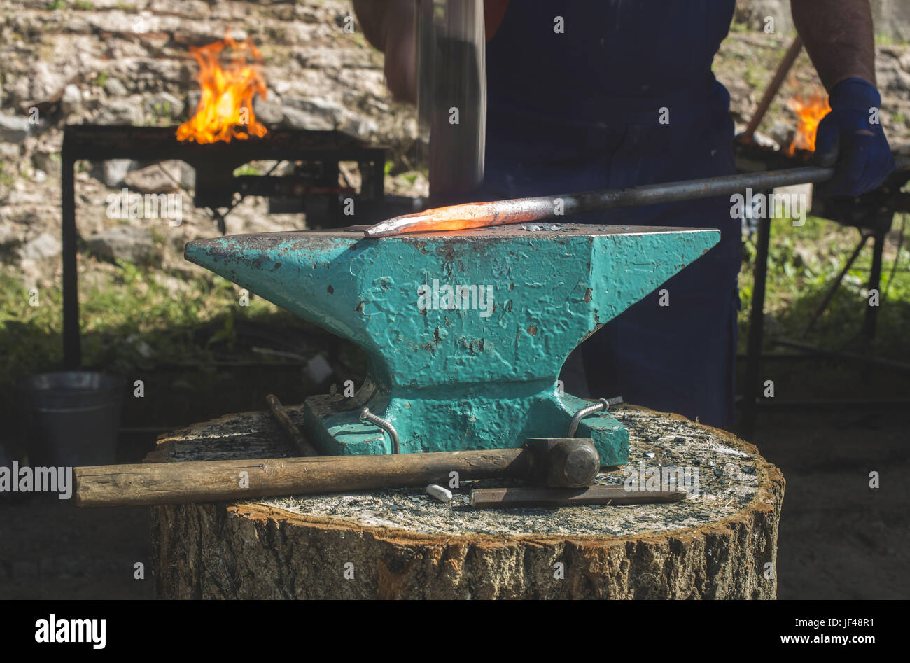 Blacksmith forges iron on anvil Stock Photo - Alamy