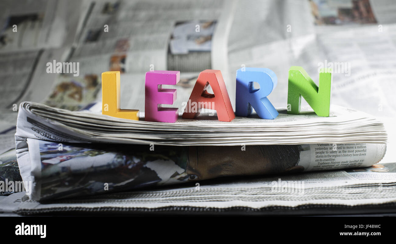 Word learn on newspaper Stock Photo - Alamy