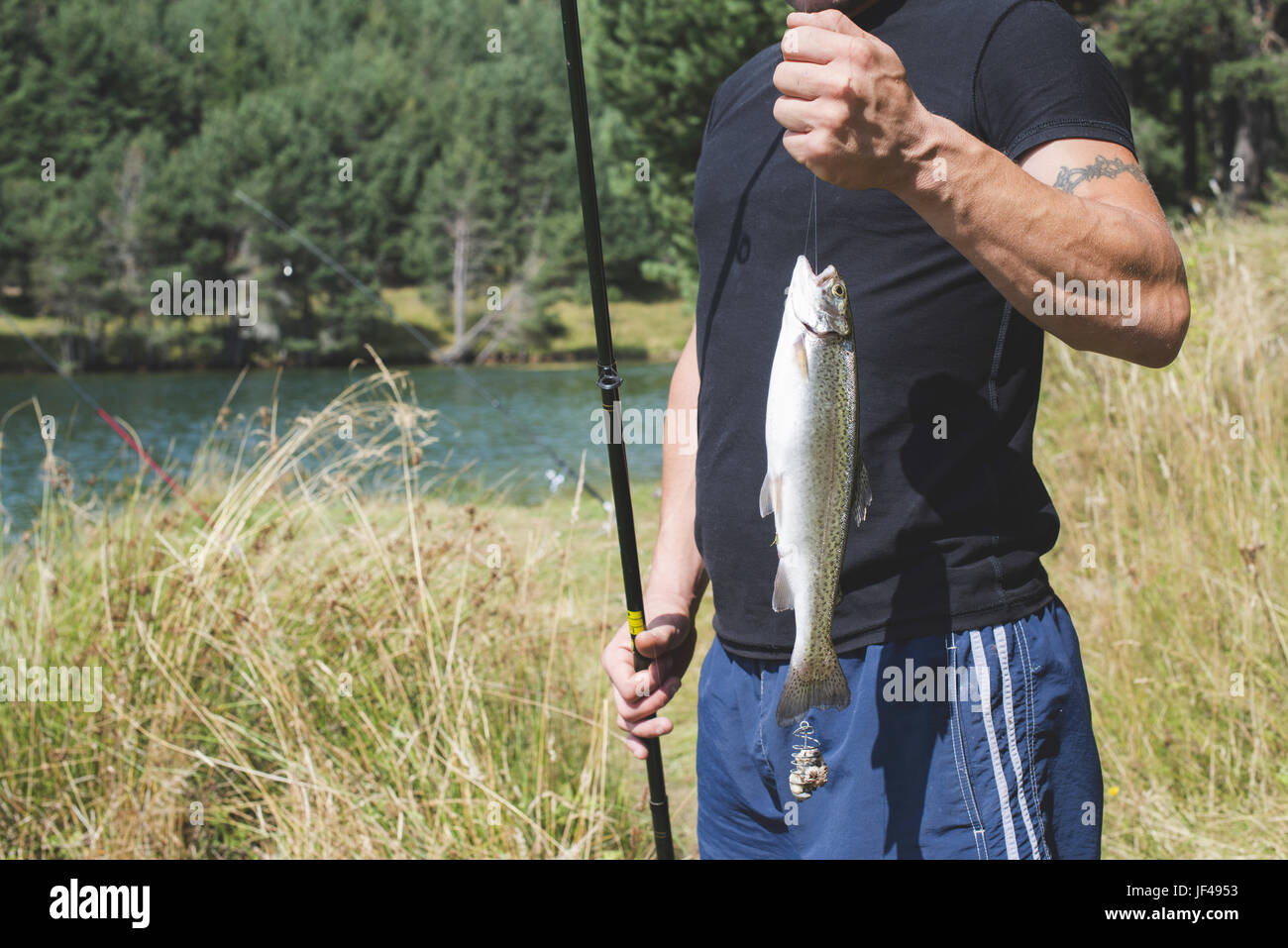 Fisherman caught a fish Stock Photo - Alamy