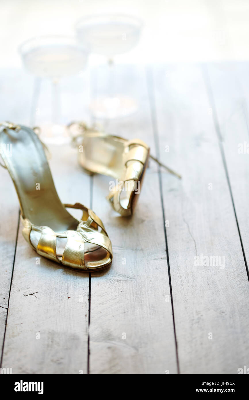 Gold colored high heels on table Stock Photo - Alamy
