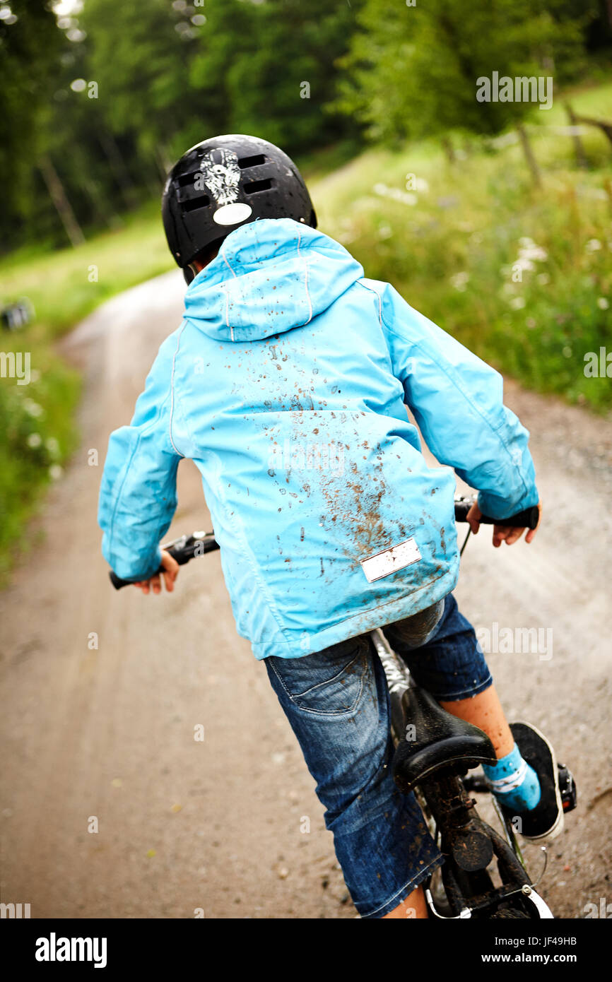 Rear view of boy on bicycle Stock Photo - Alamy