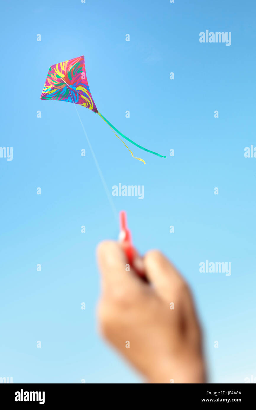 Hand holding kite Stock Photo - Alamy