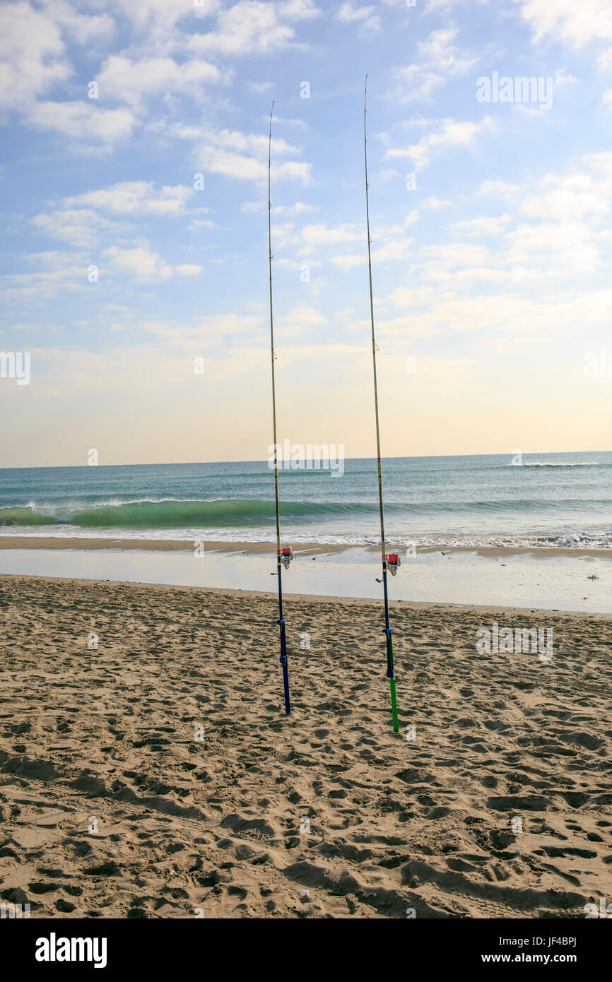 two Fishing rods on the beach Stock Photo - Alamy