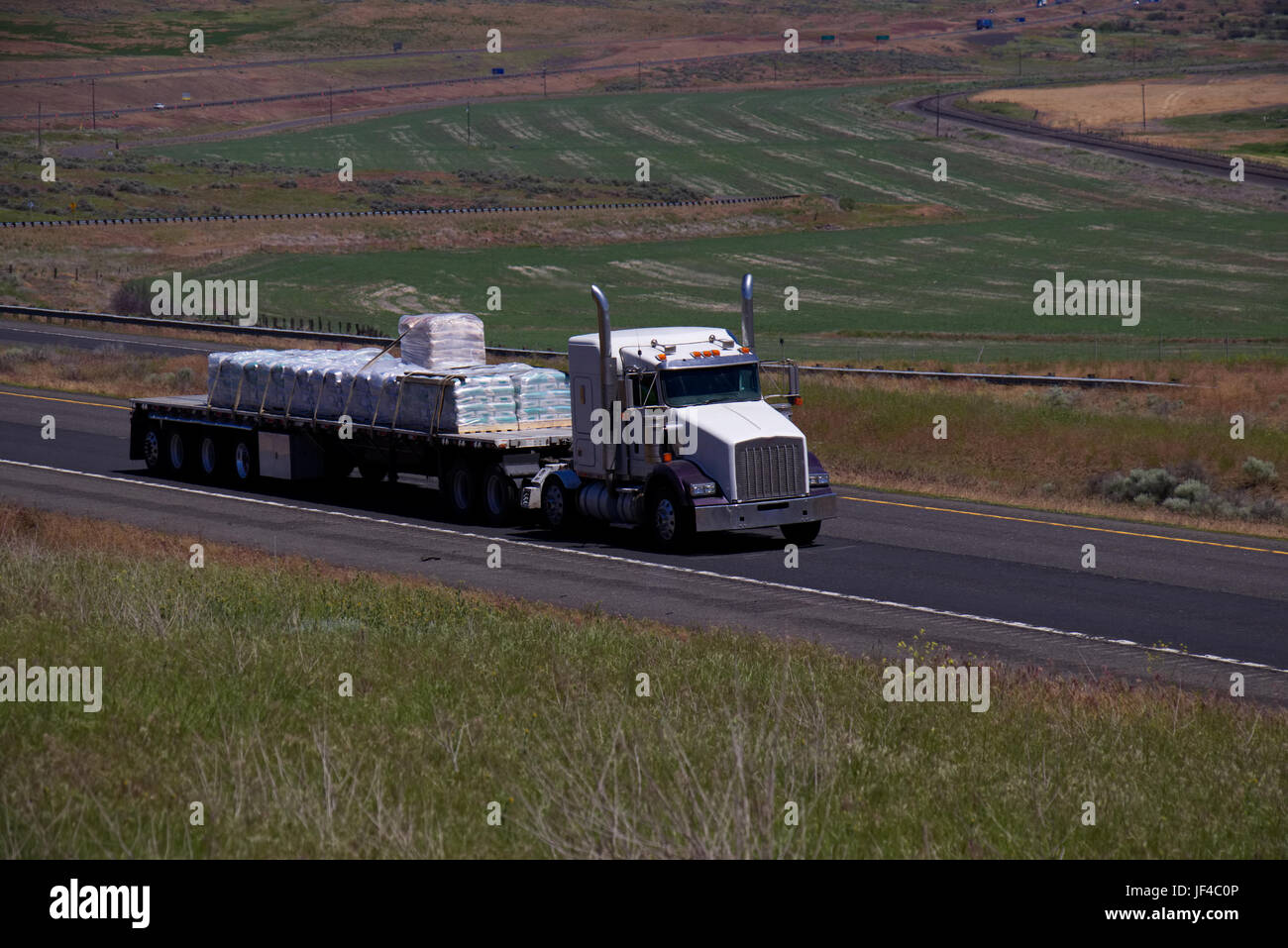 White Semi-Truck / Loaded Flatbed Trailer Stock Photo - Alamy