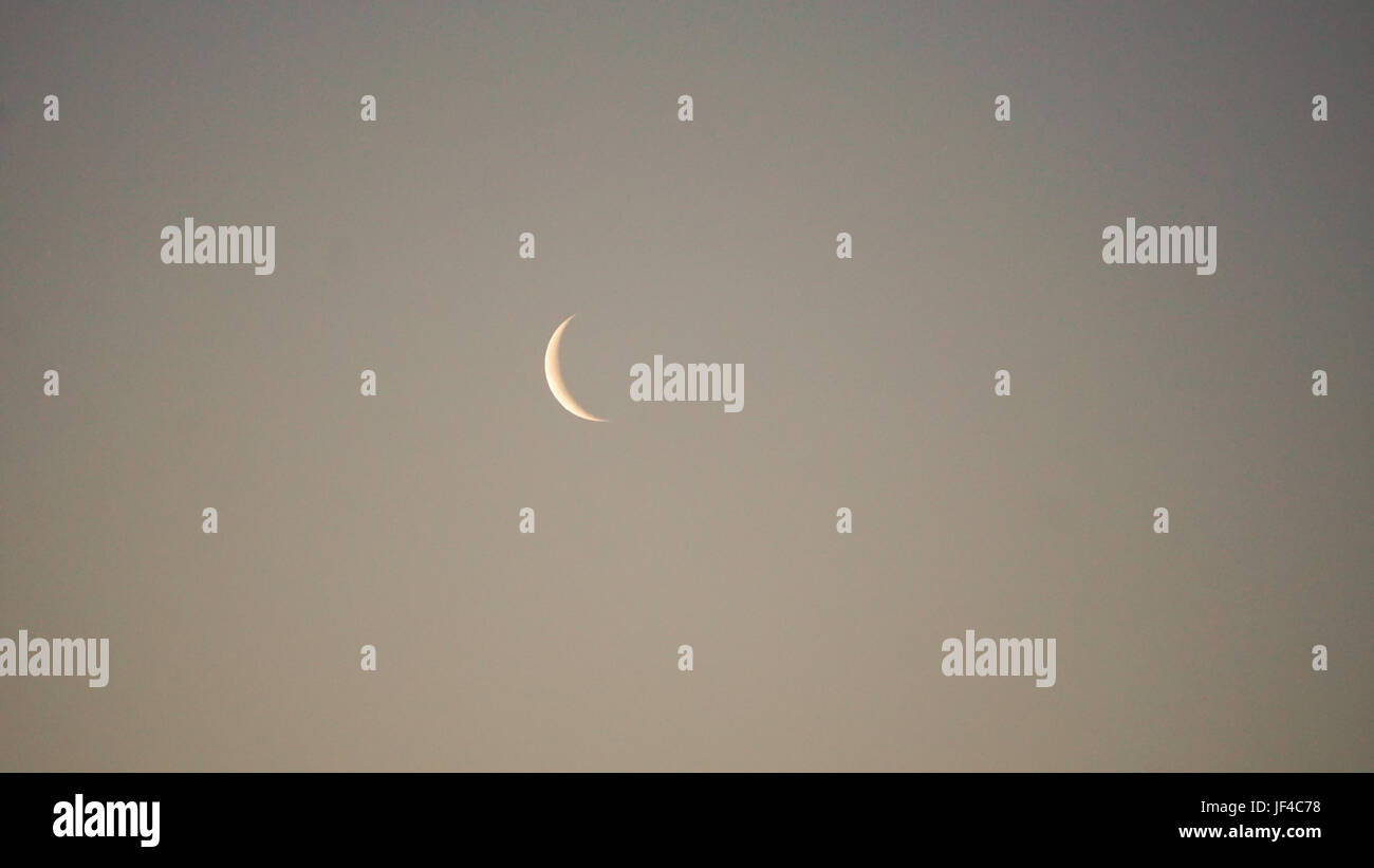 The Crescent moon hanging in the morning sky Stock Photo - Alamy