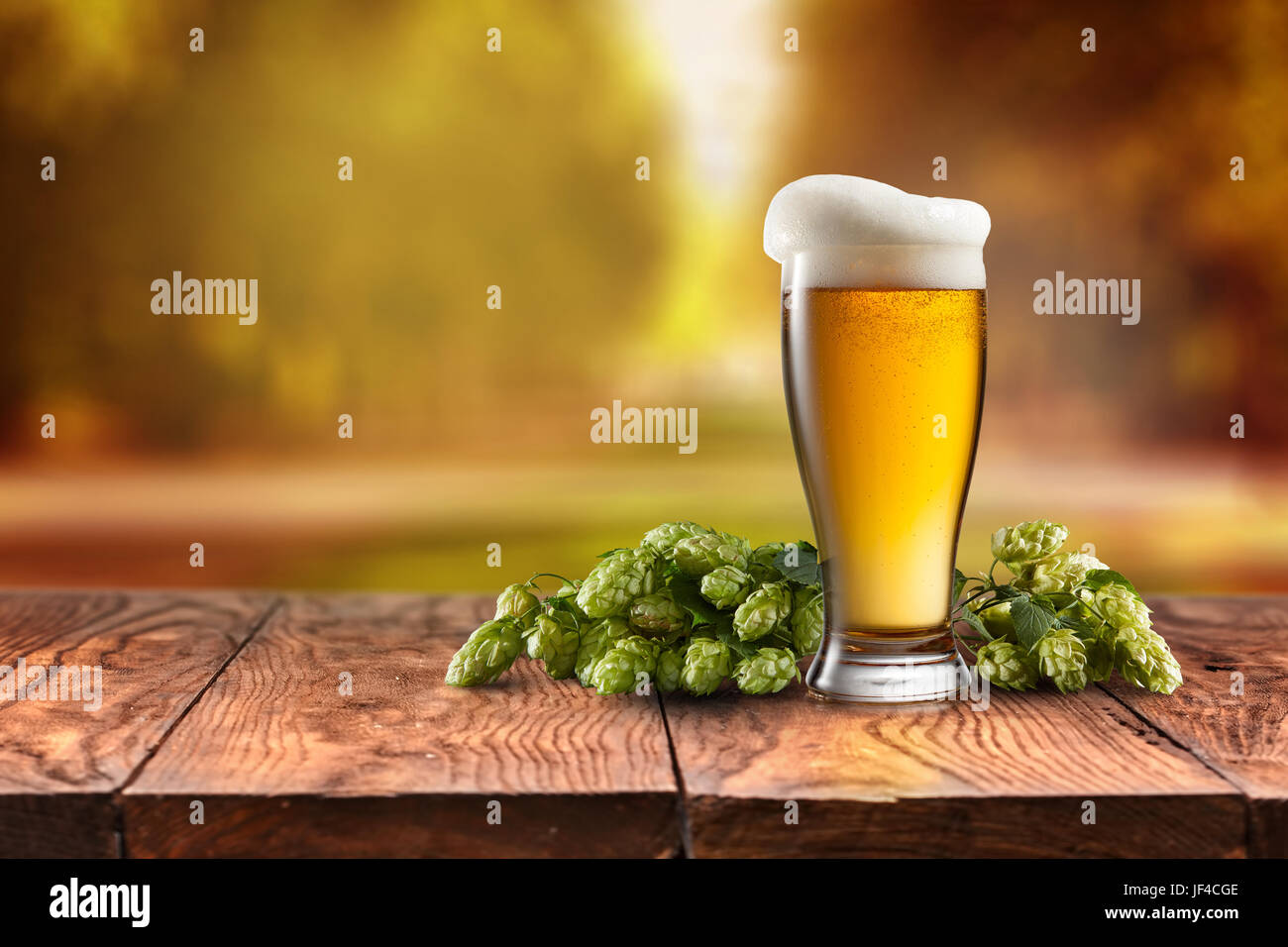 Beer glass served on wooden desk Stock Photo - Alamy