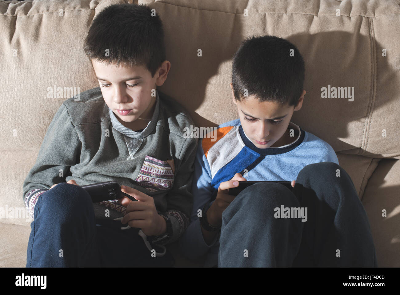 Children playing with their smartphones Stock Photo - Alamy