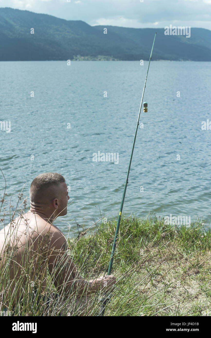 Man on fishing with rod Stock Photo - Alamy