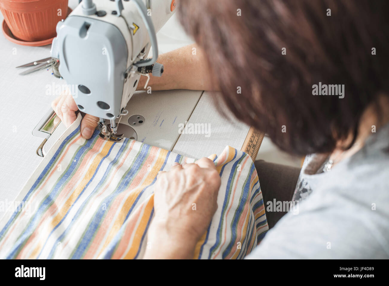 Women sew on sewing machine Stock Photo - Alamy