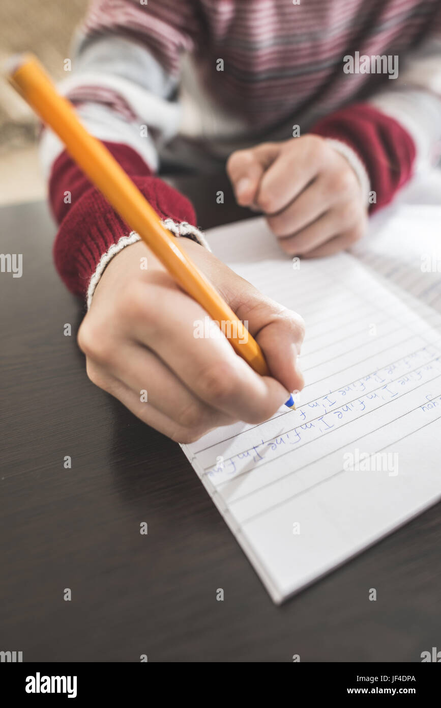 Child write in a notebook Stock Photo - Alamy