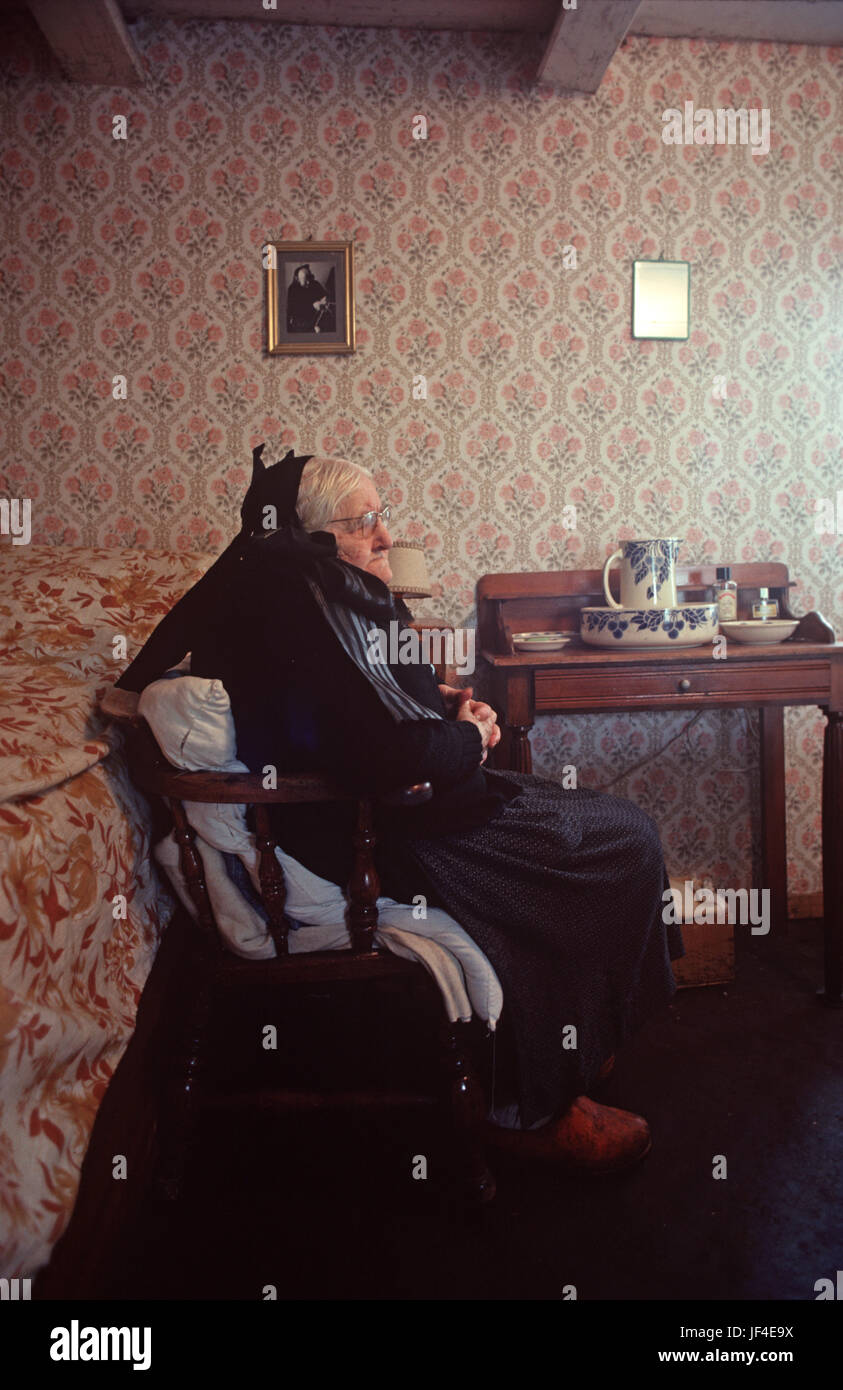 Old Breton lady sitting in armchair in Island of Ushant house, Brittany ...