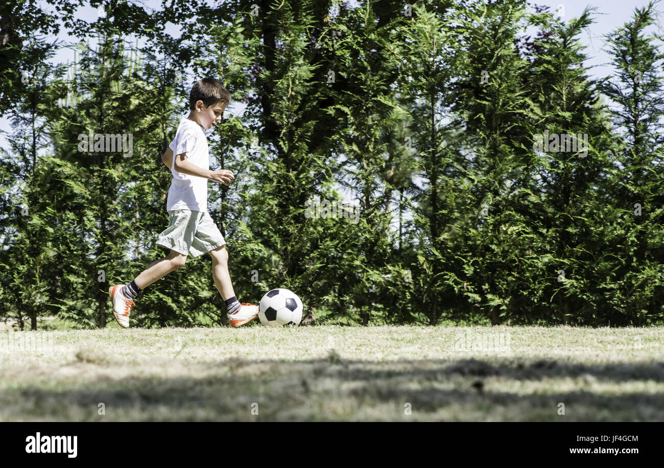 Child playing football in a stadium Stock Photo - Alamy