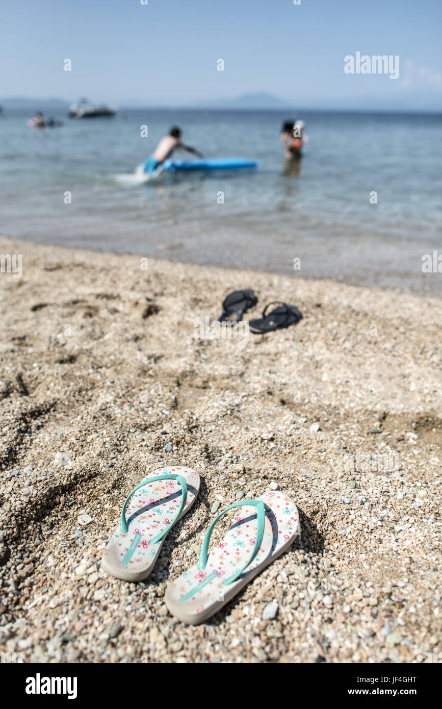 Slippers in the sand on the beach Stock Photo - Alamy