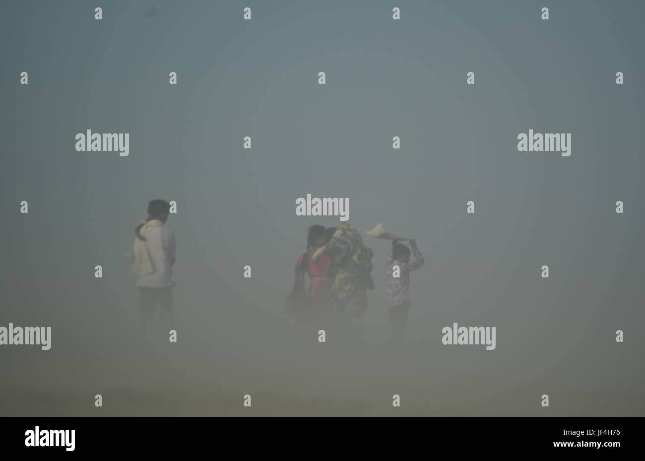 Allahabad, India. 28th June, 2017. Pilgrims walks trough dust storm at ...