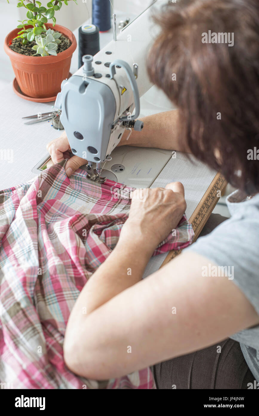 Women sew on sewing machine Stock Photo - Alamy