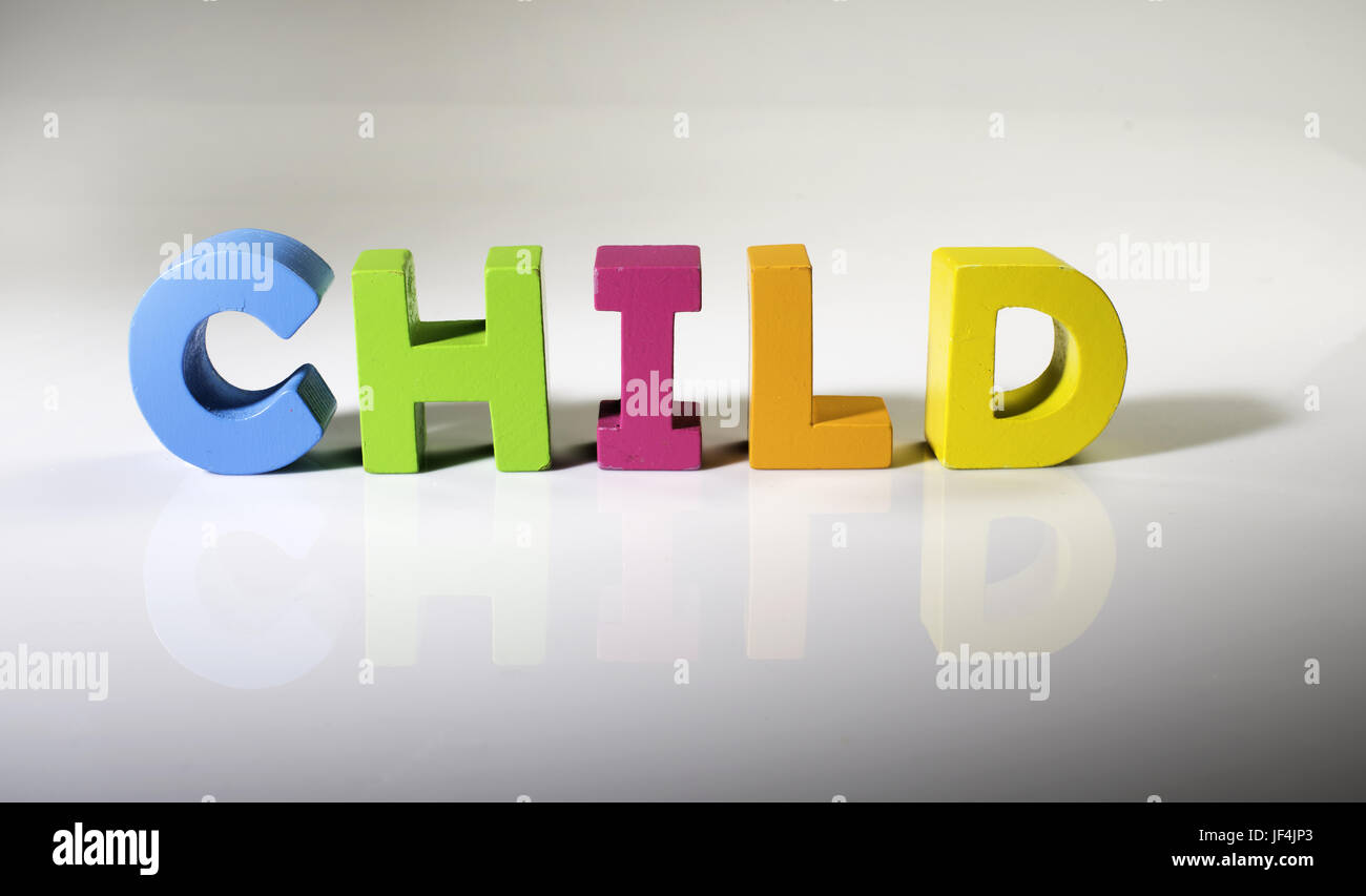 Multicolored text child made of wood Stock Photo - Alamy