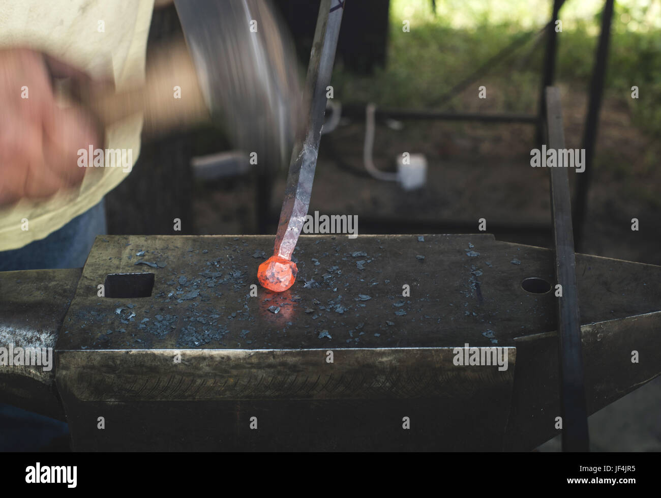 Blacksmith forges iron on anvil Stock Photo - Alamy