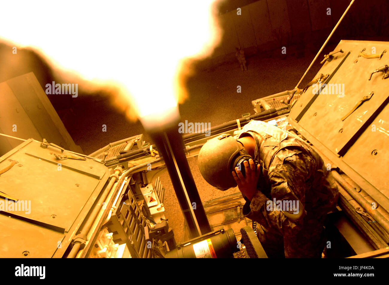 060601-F-1644L-060 An Army soldier holds his ears as he uses a 120mm ...