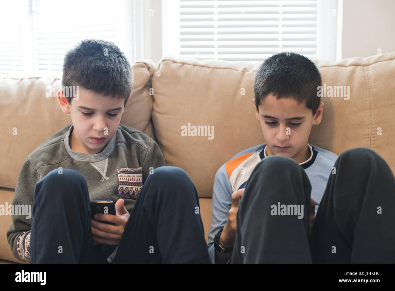 Children playing with their smartphones Stock Photo - Alamy
