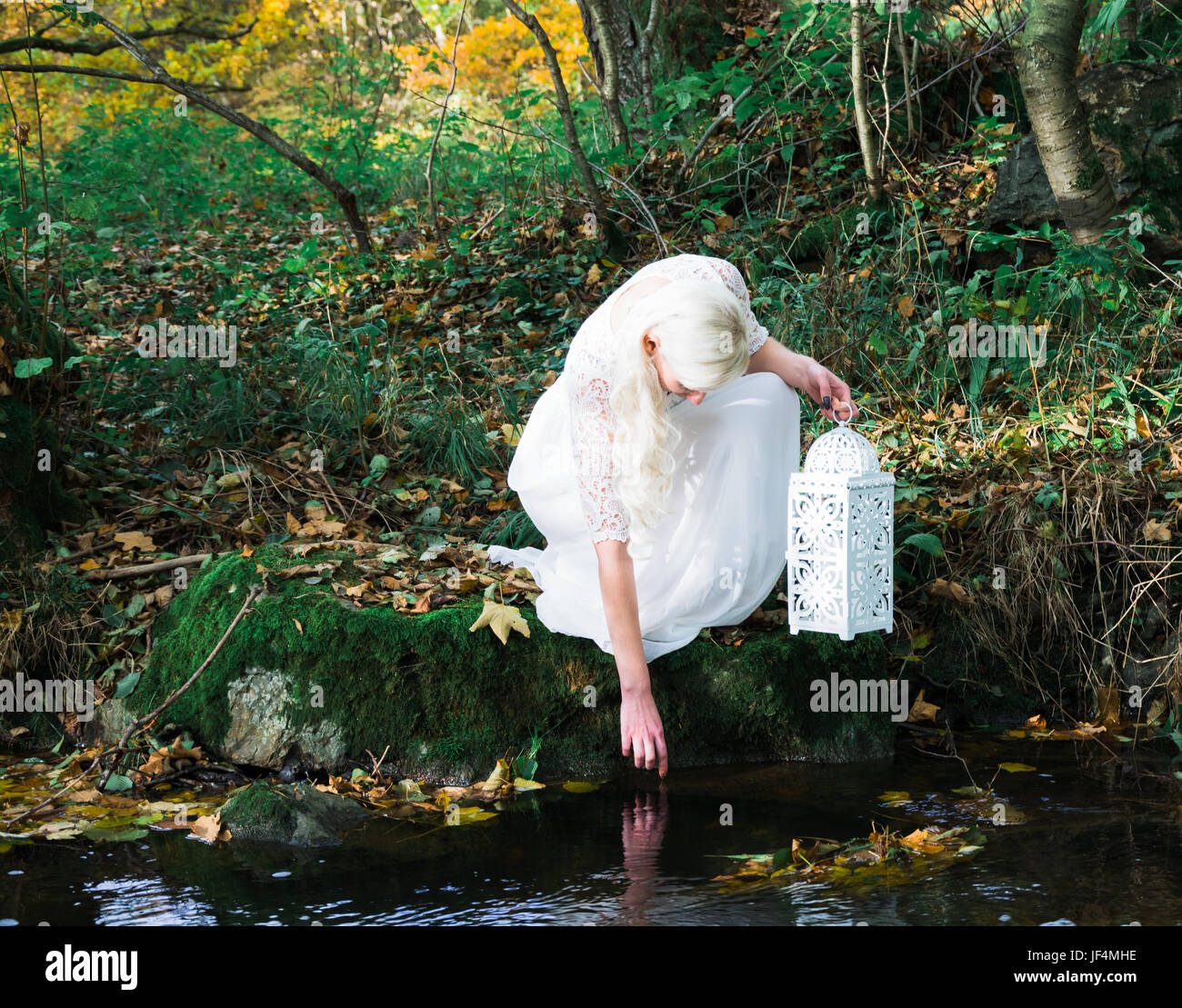 woman at a forest brook shore Stock Photo - Alamy