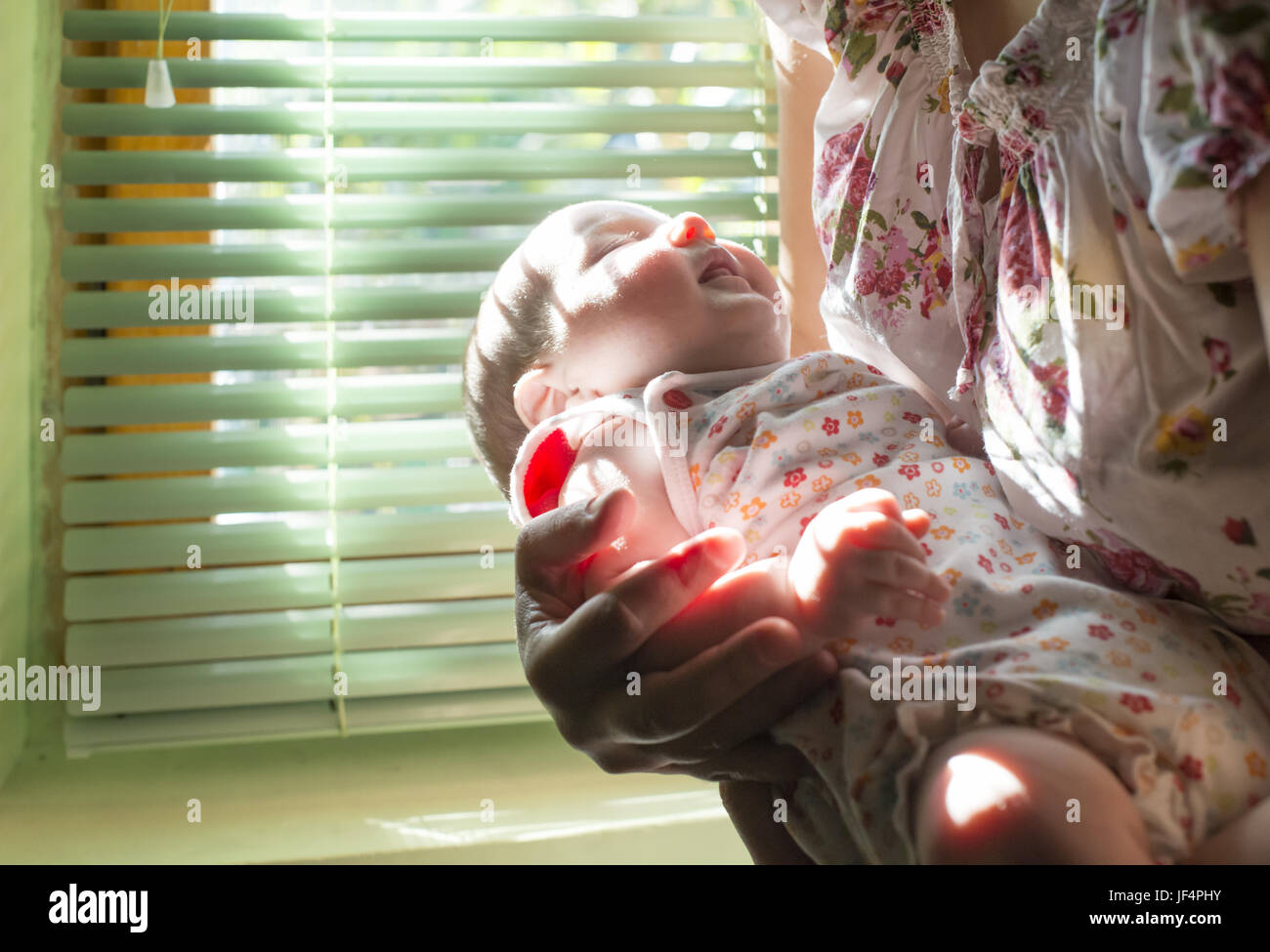 Baby and mom to the window Stock Photo - Alamy