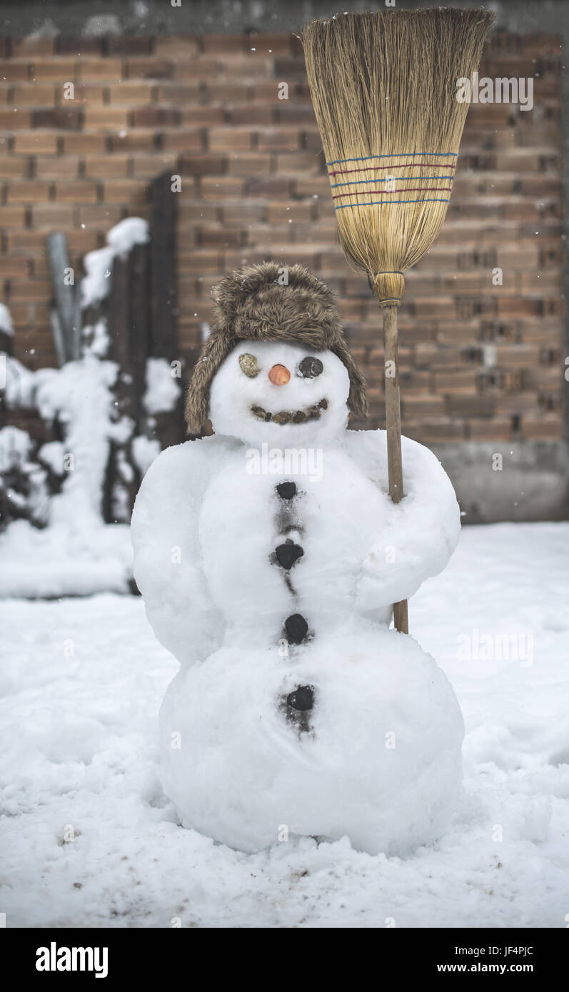 Snowman in the yard Stock Photo - Alamy