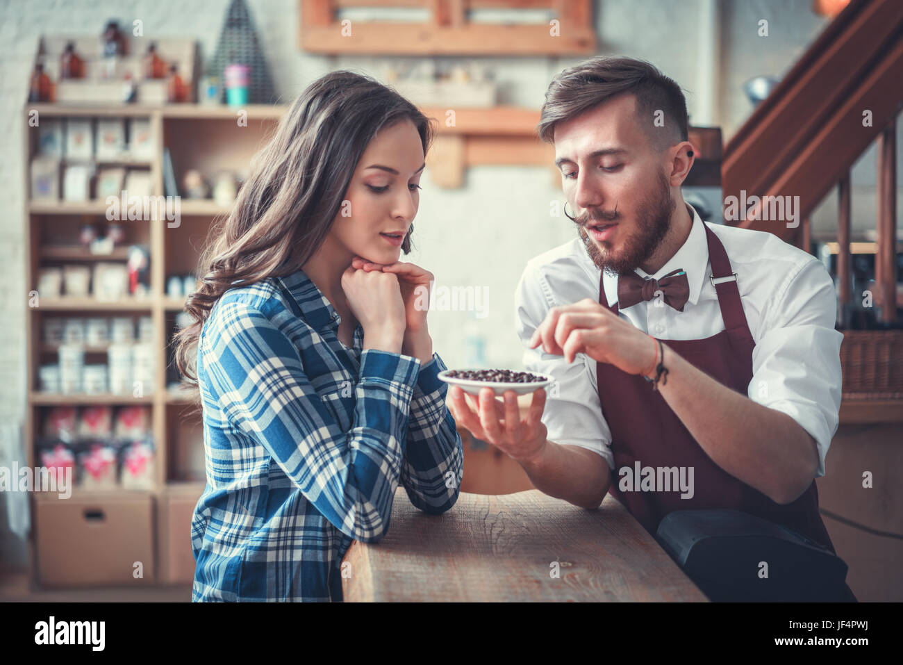 Barista with customer Stock Photo - Alamy