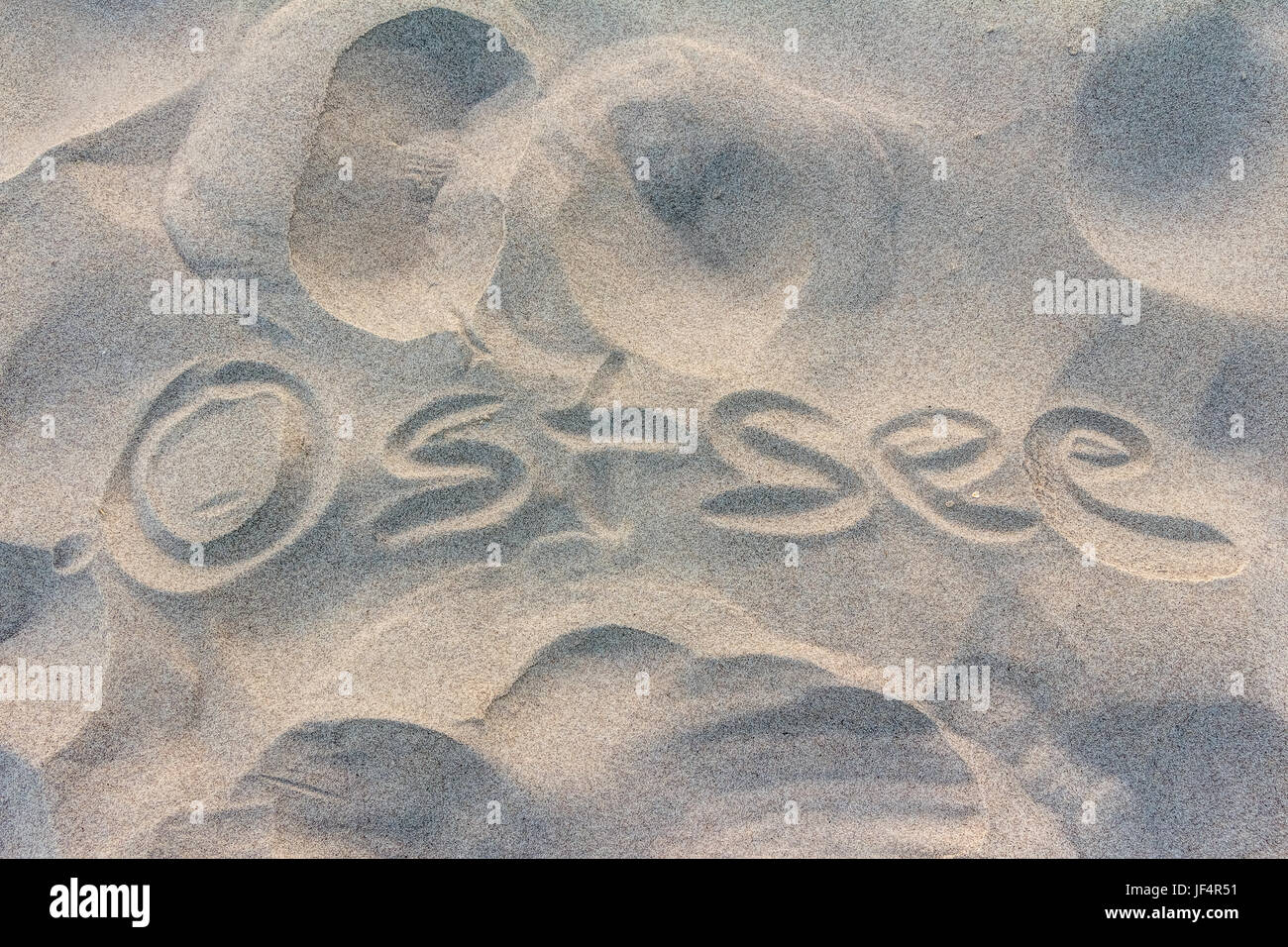 Painted letters in sand Stock Photo - Alamy