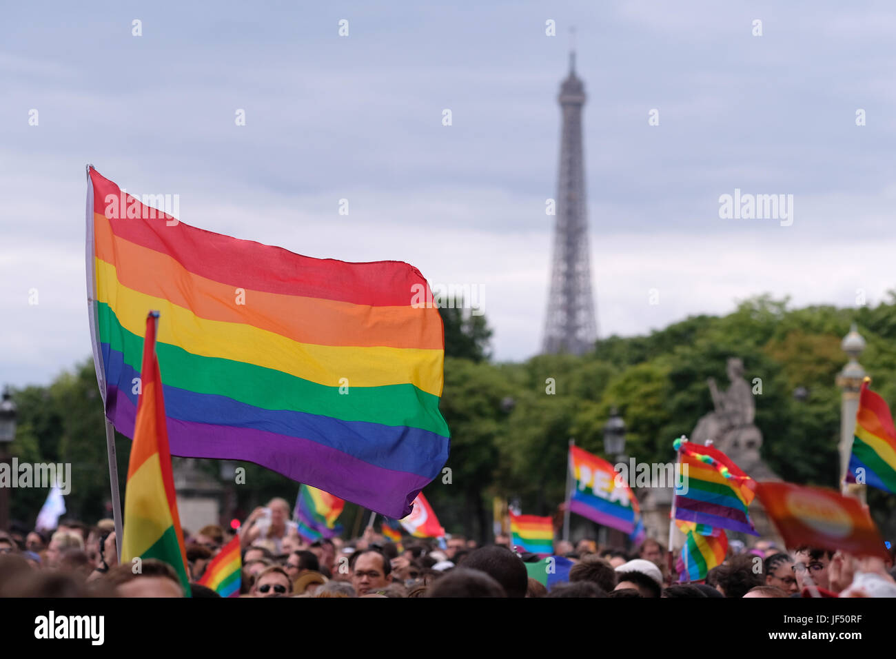 A rainbow flag flutters in front of the Eiffel Tower during a rally ...