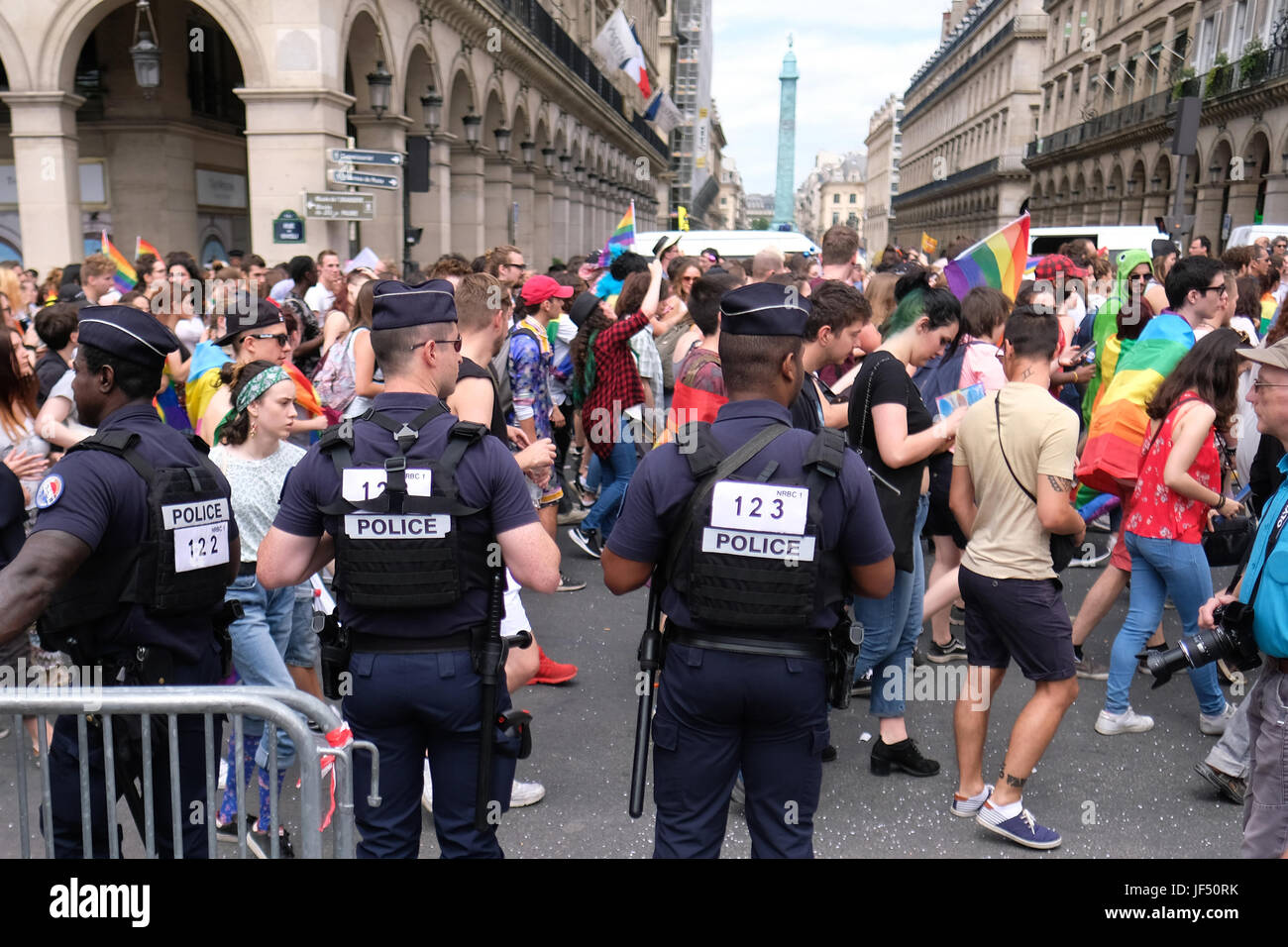 Police officer stand guard as people take part in the Paris Gay Pride ...