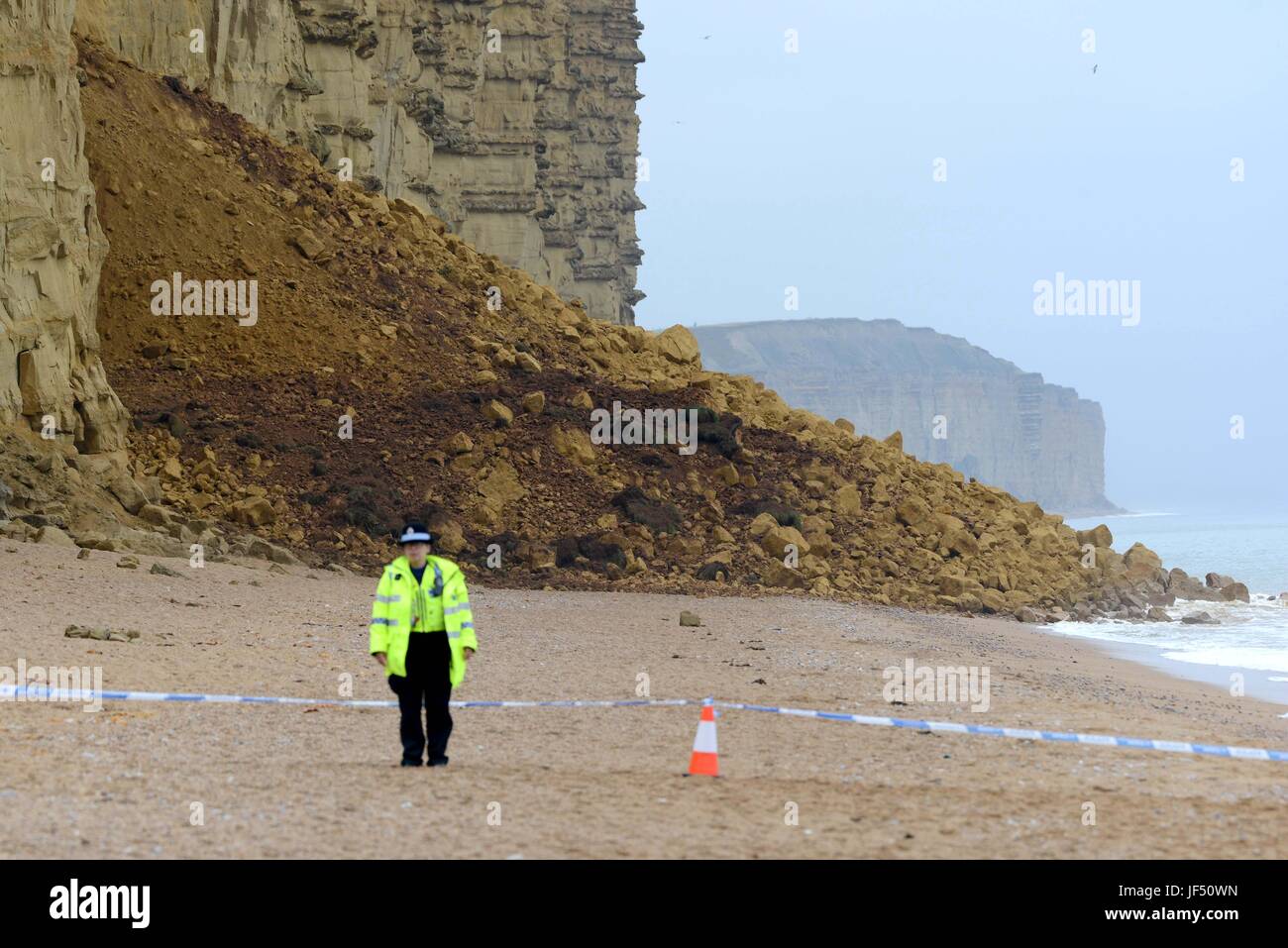 West Bay, Dorset, UK. 29th June, 2017. Police close East Beach and cliff path after a massive ...